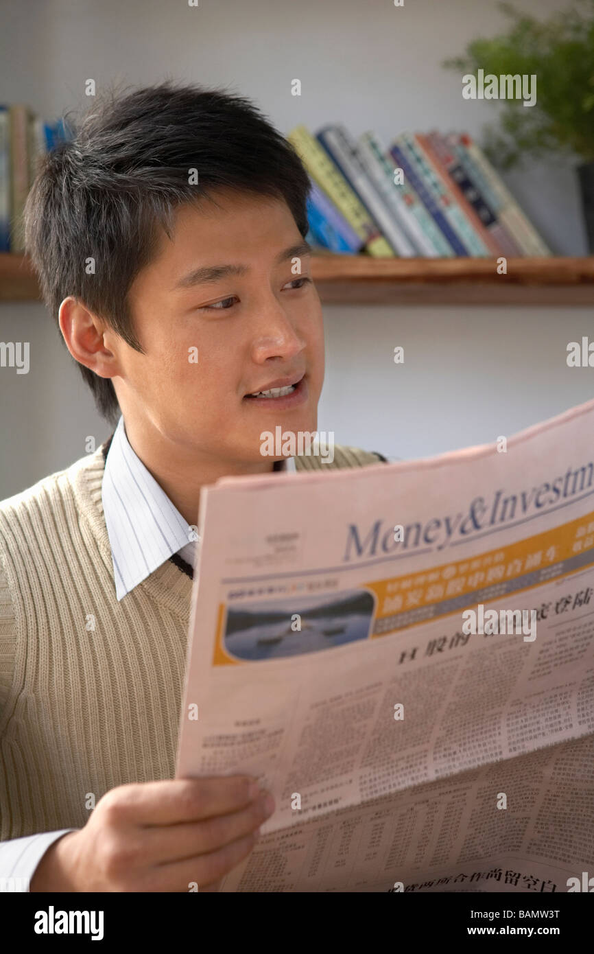 Man Sitting At Table, Reading A Newspaper Stock Photo - Alamy