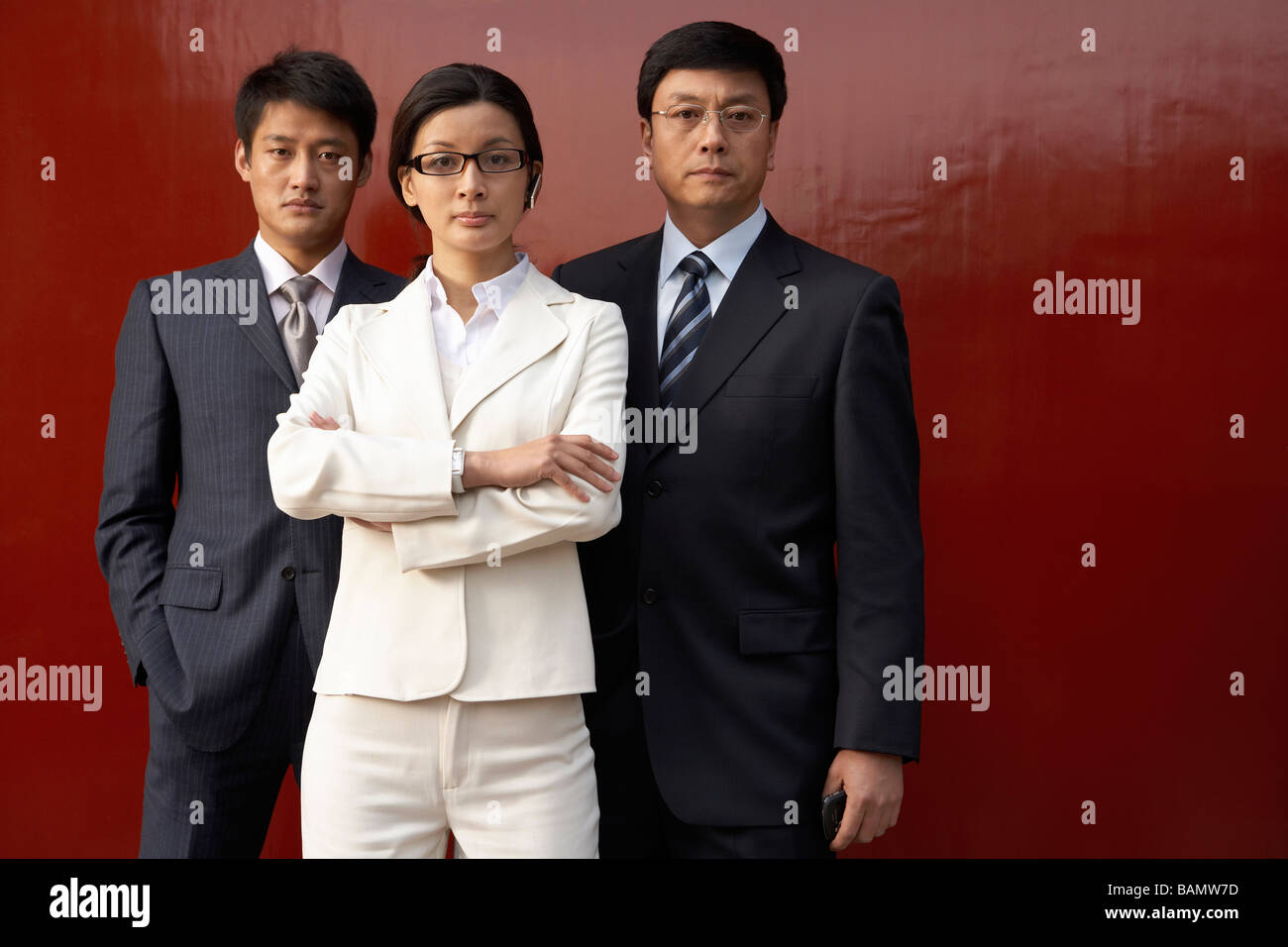 Three Business People Standing In Group Stock Photo - Alamy