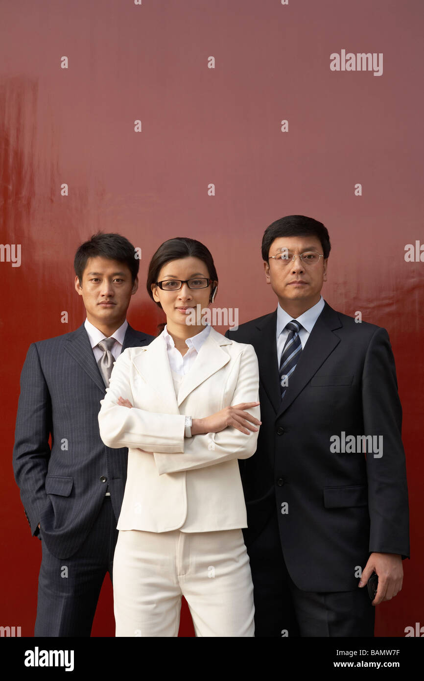 Three Business People Standing In Group Stock Photo - Alamy