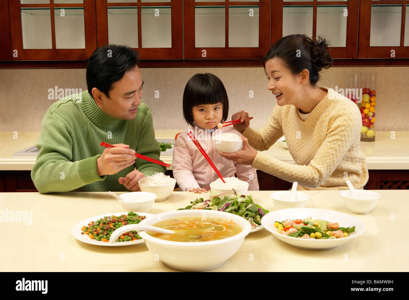 Mother trying to feed child hi-res stock photography and images - Alamy