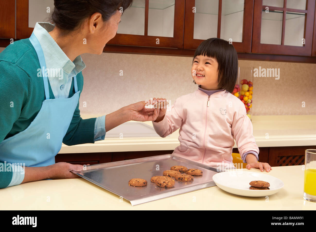 Grandmother and granddaughter making cookies together Stock Photo - Alamy