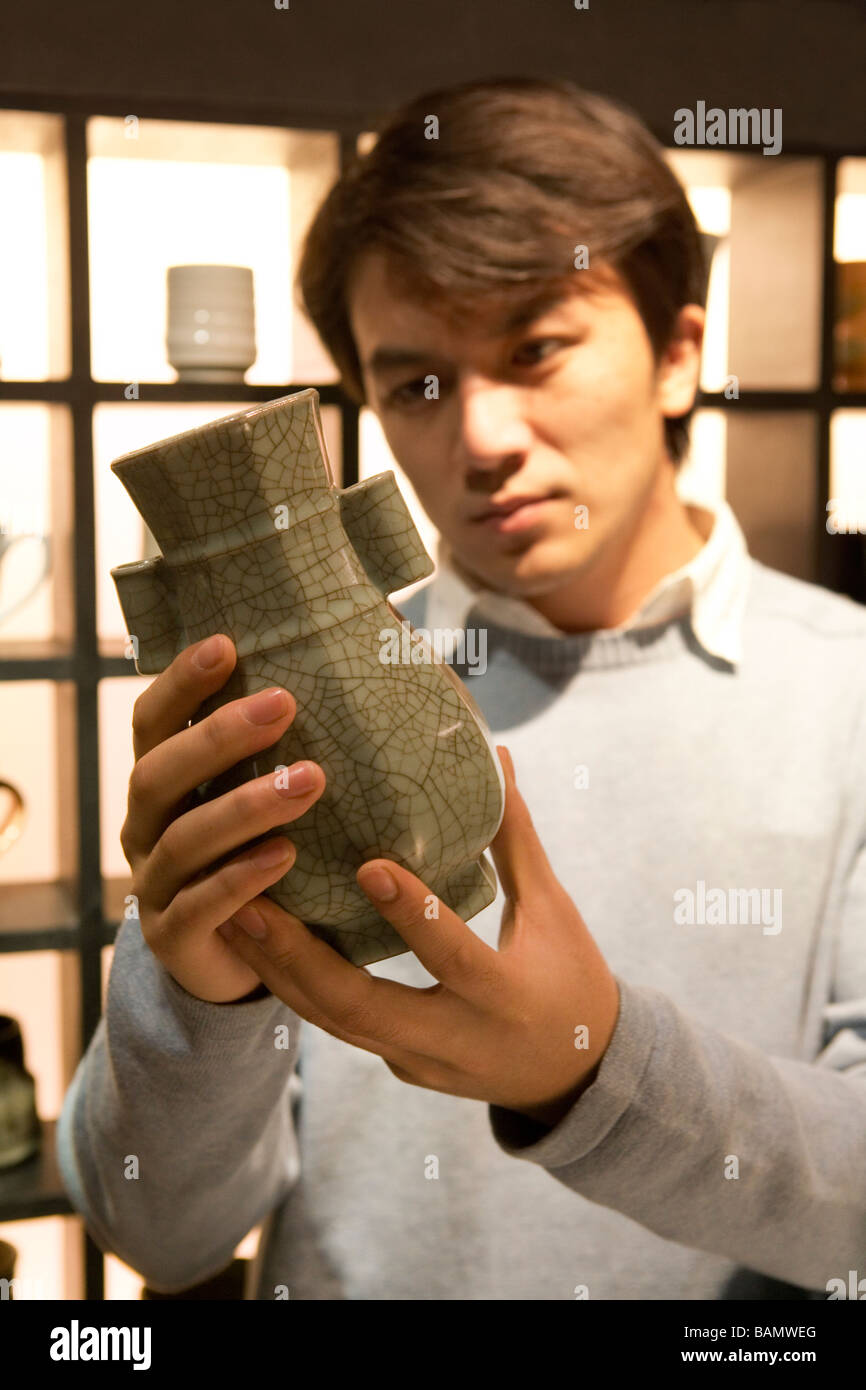 Man young shelves cups hi-res stock photography and images - Alamy