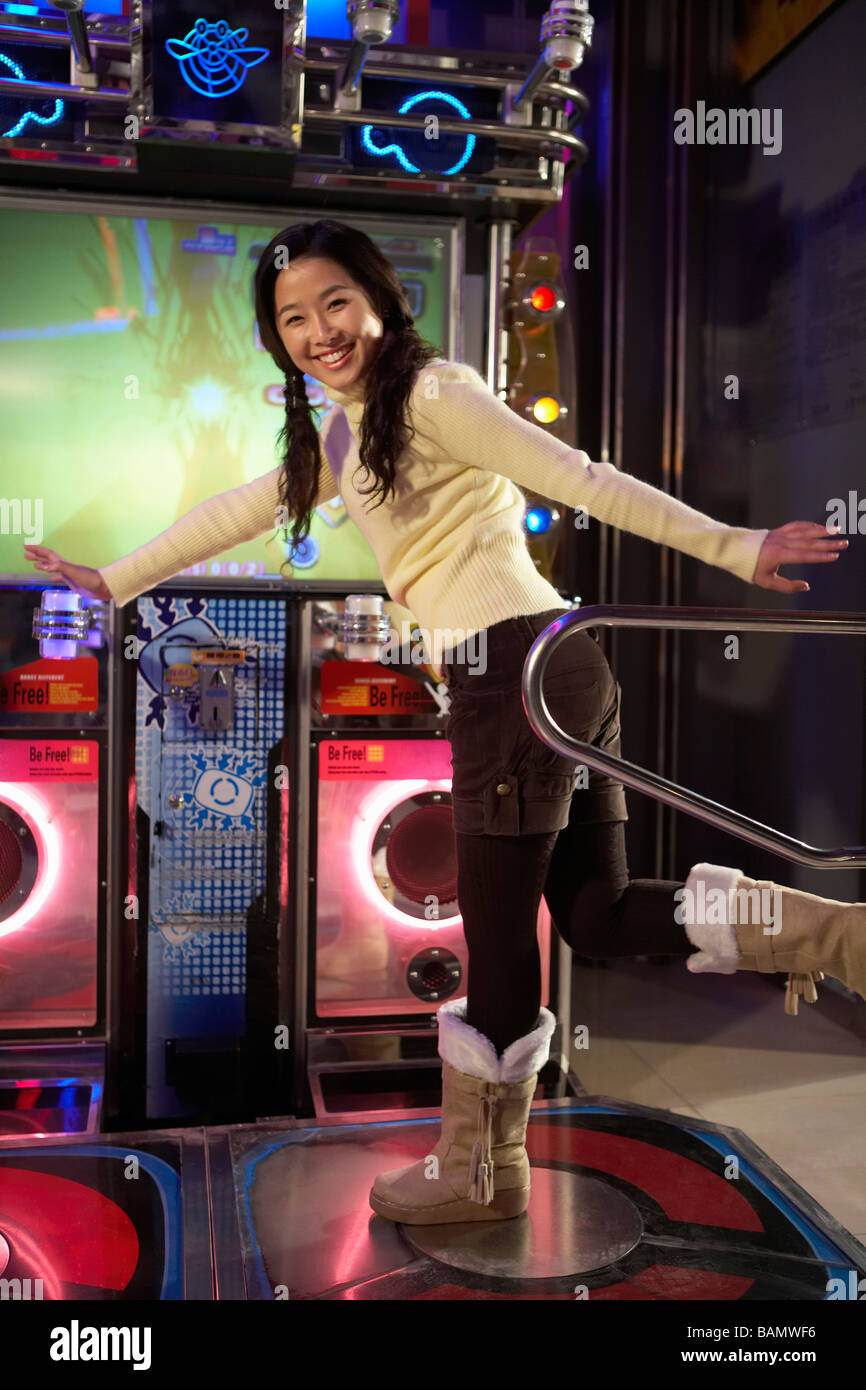 Teenage Girl On Dancing Game At Arcade Stock Photo - Alamy
