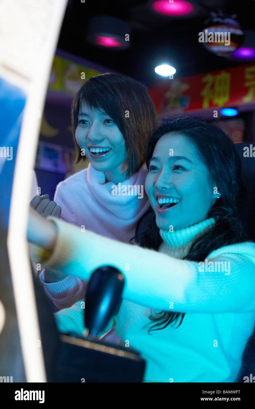 Teenage Girls Playing Games At Arcade Stock Photo - Alamy