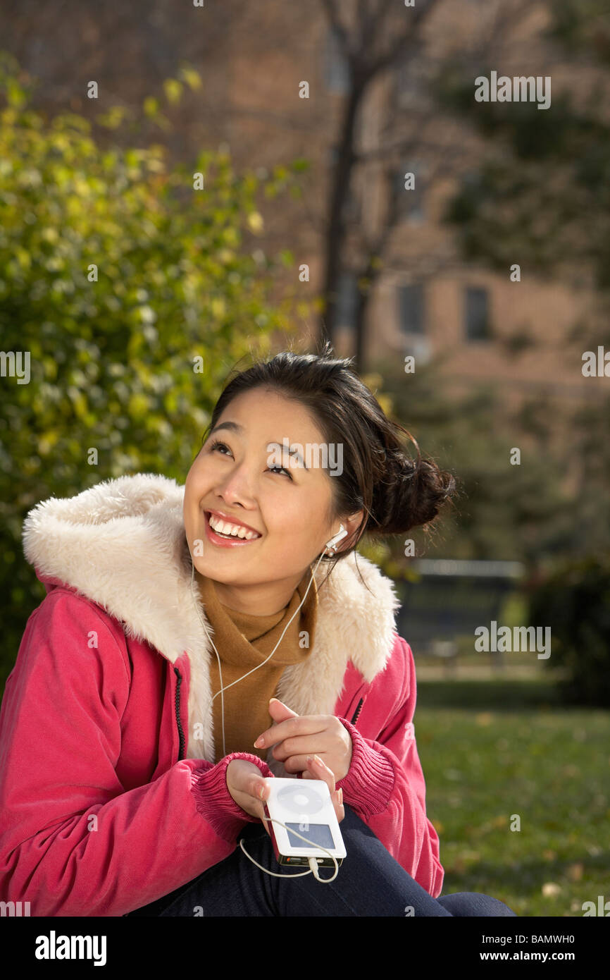 Young Woman Listening To MP3 Player Stock Photo - Alamy