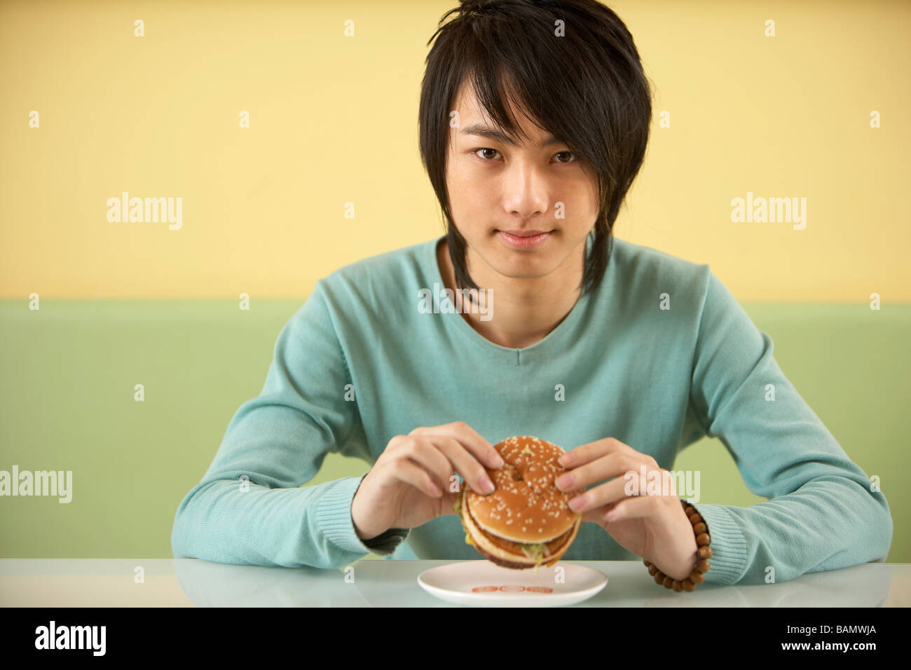Teenage Boy Eating Hamburger Stock Photo - Alamy
