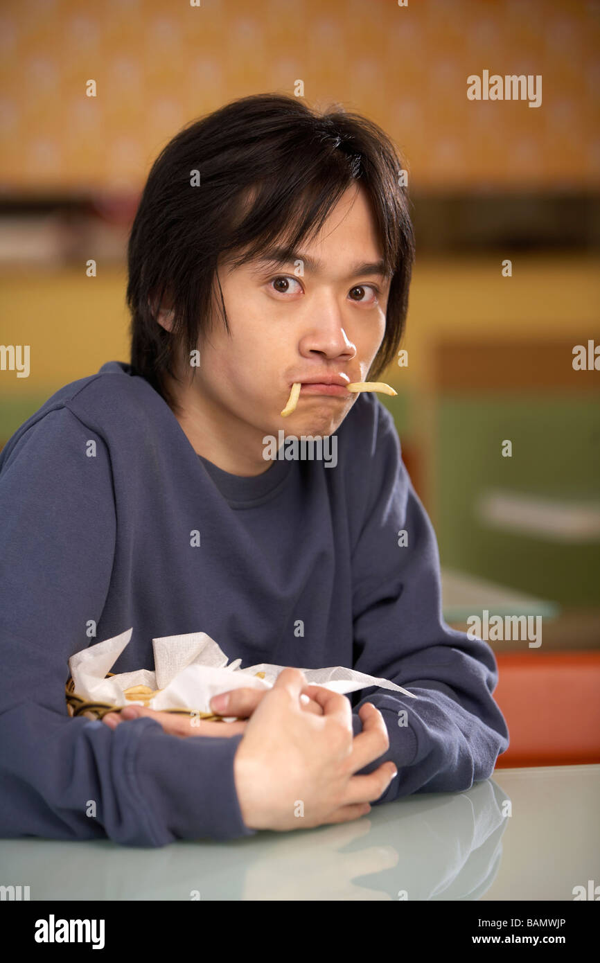Teenage Boy Guarding French Fries Stock Photo - Alamy