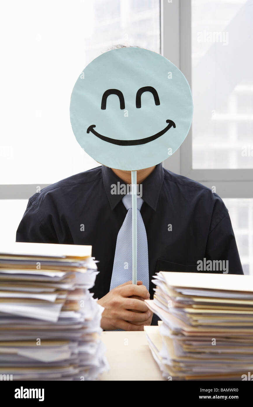 Businessman With Smiley-Face Sign Stock Photo - Alamy