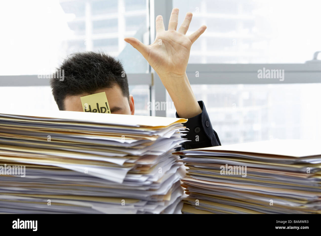 Businessman With Sticky-Note On Forehead Disappearing Behind Papers ...