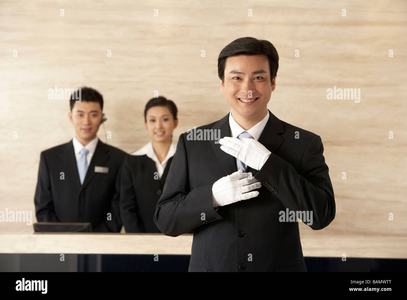Young Employees Standing In Hotel Reception Stock Photo - Alamy