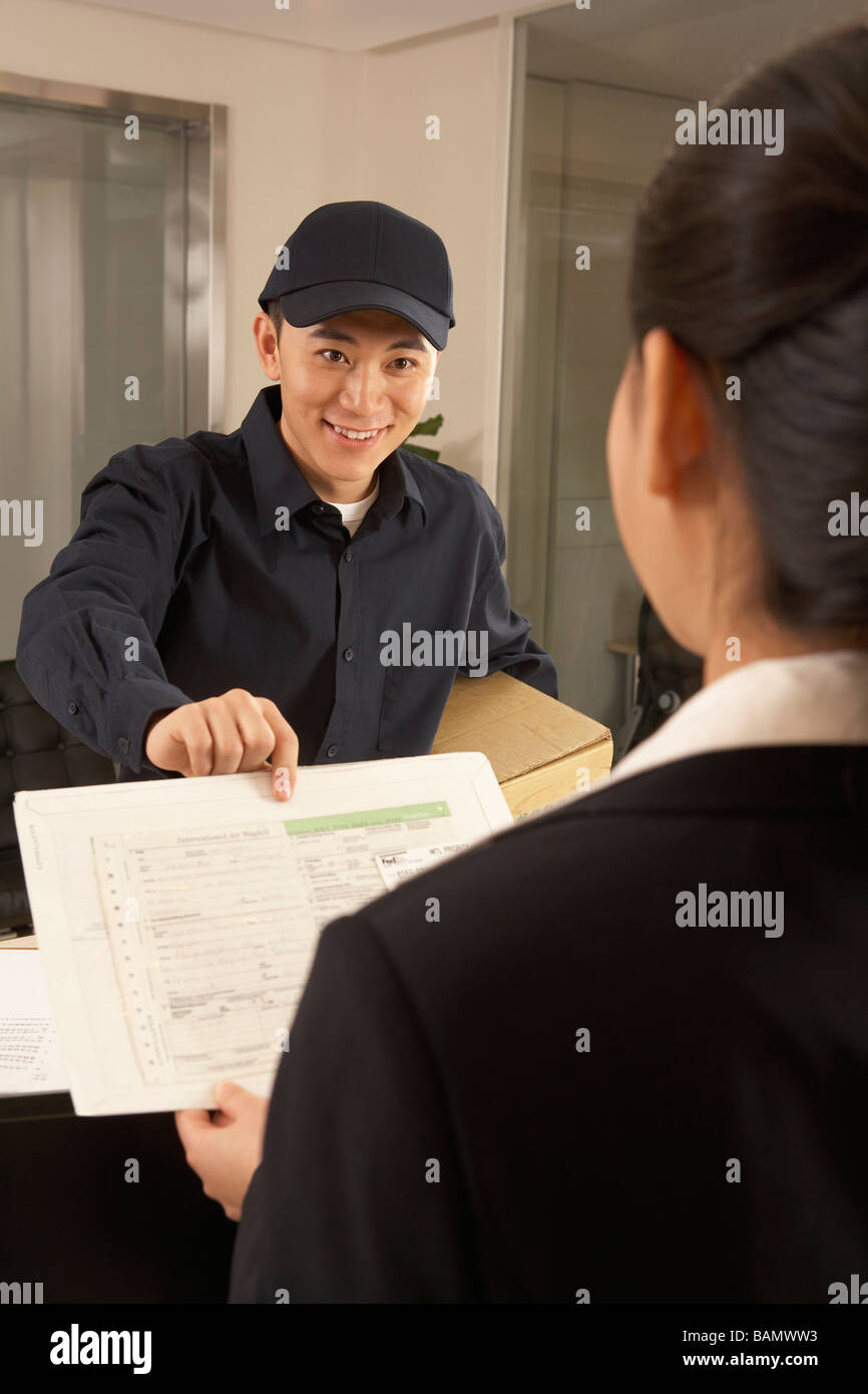 Young Man Making Delivery To Hotel Reception Stock Photo - Alamy