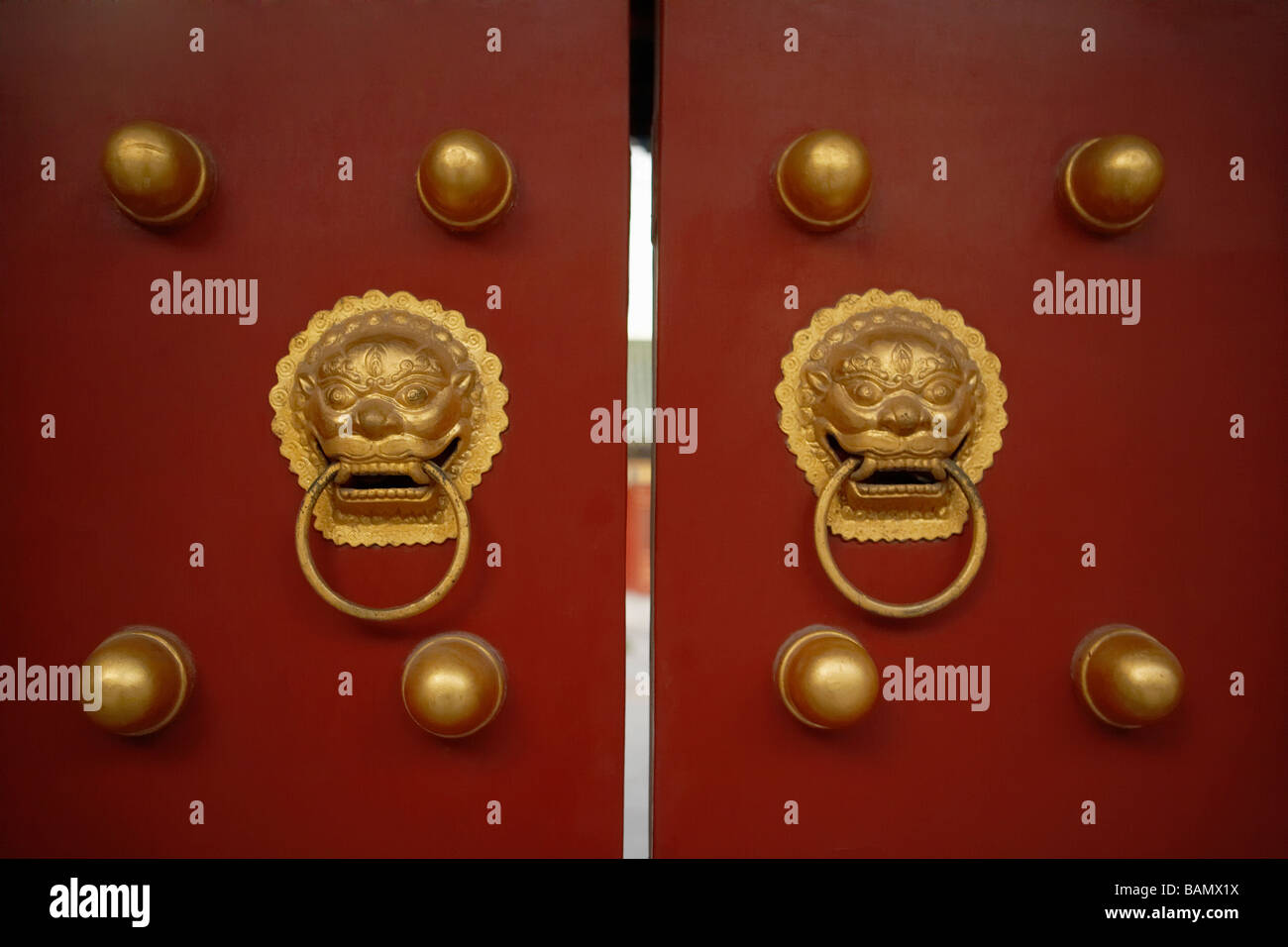 Gold Metal Door Knockers On A Red Door Stock Photo - Alamy