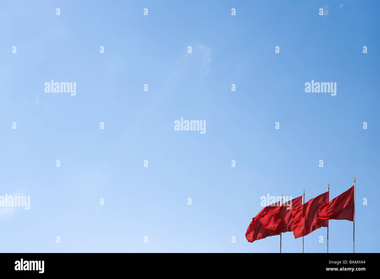 Red Flags Flying Against Blue Sky Stock Photo - Alamy