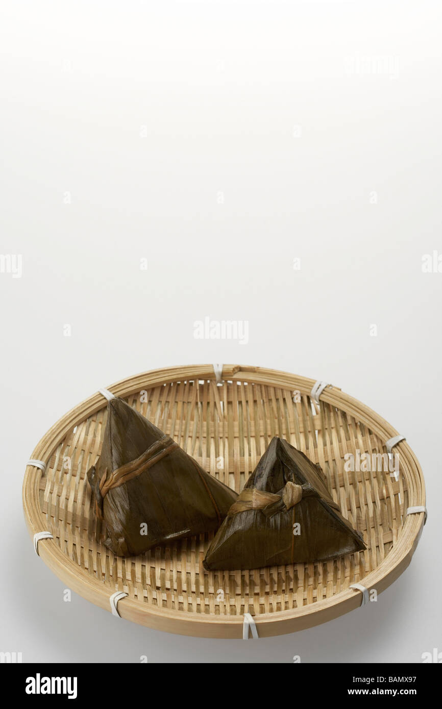Zongzi in a woven bowl Stock Photo - Alamy