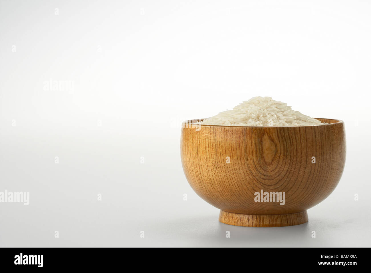 Rice in a wooden bowl Stock Photo - Alamy