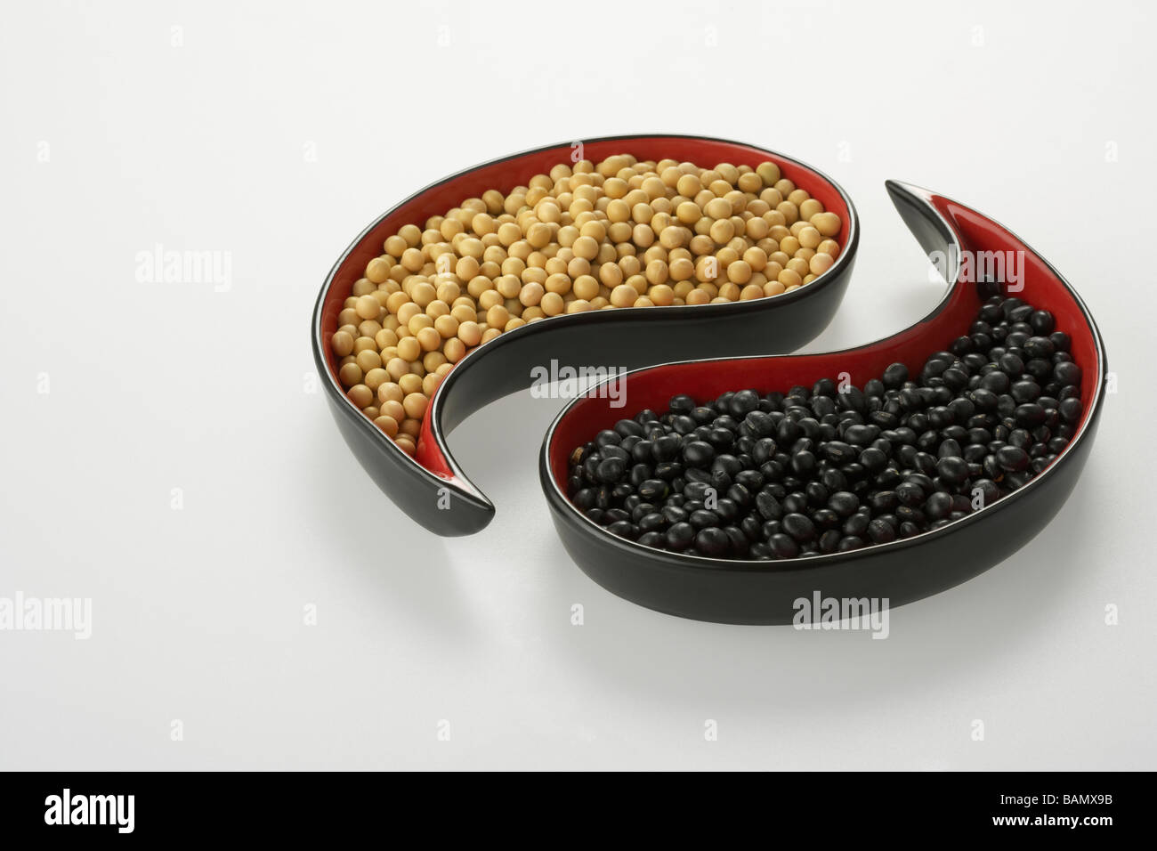 Legumes and black beans in yin yang style dishes Stock Photo - Alamy