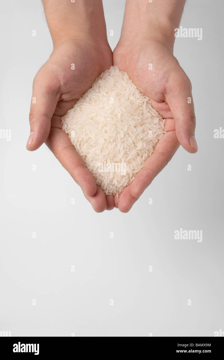 Cupped hands holding rice Stock Photo - Alamy