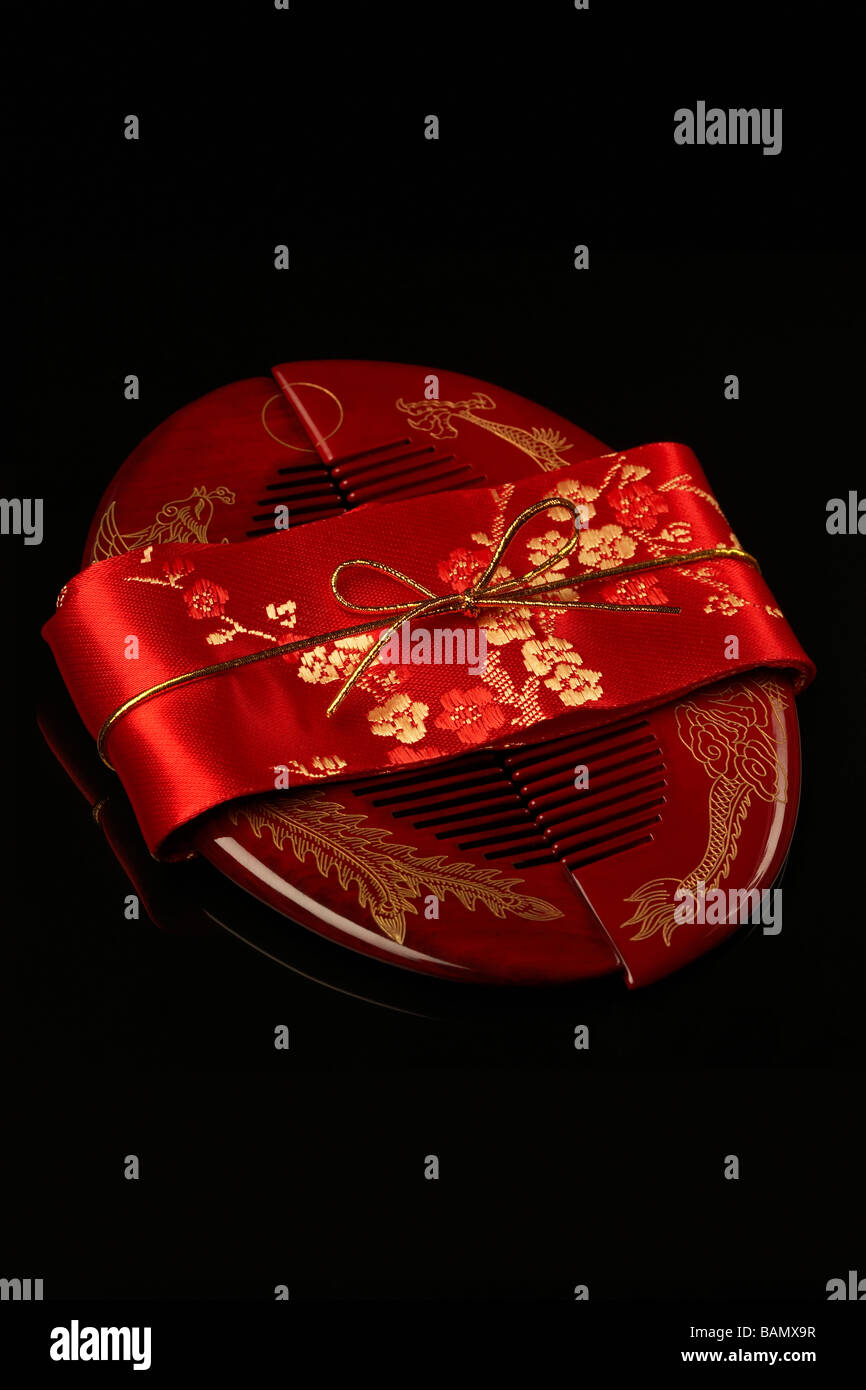 A set of red Chinese hair combs wrapped in a red ribbon Stock Photo - Alamy