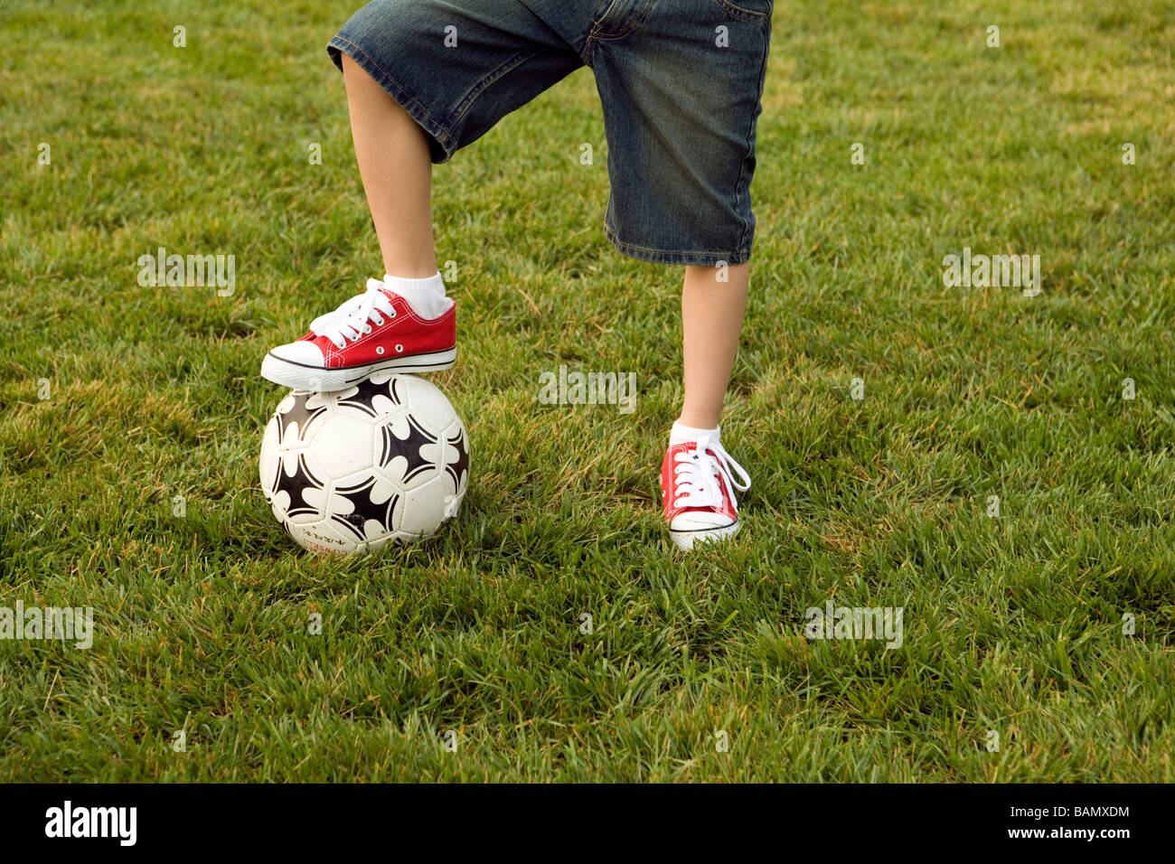 Boy Standing With One Foot On Soccer Ball Stock Photo - Alamy