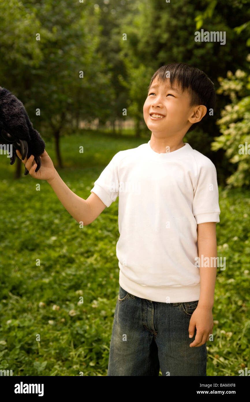 Young Boy Holding An Animal Paw Stock Photo - Alamy