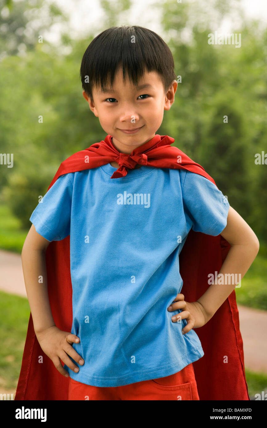 Boy In Red Cape Playing In Garden Stock Photo - Alamy