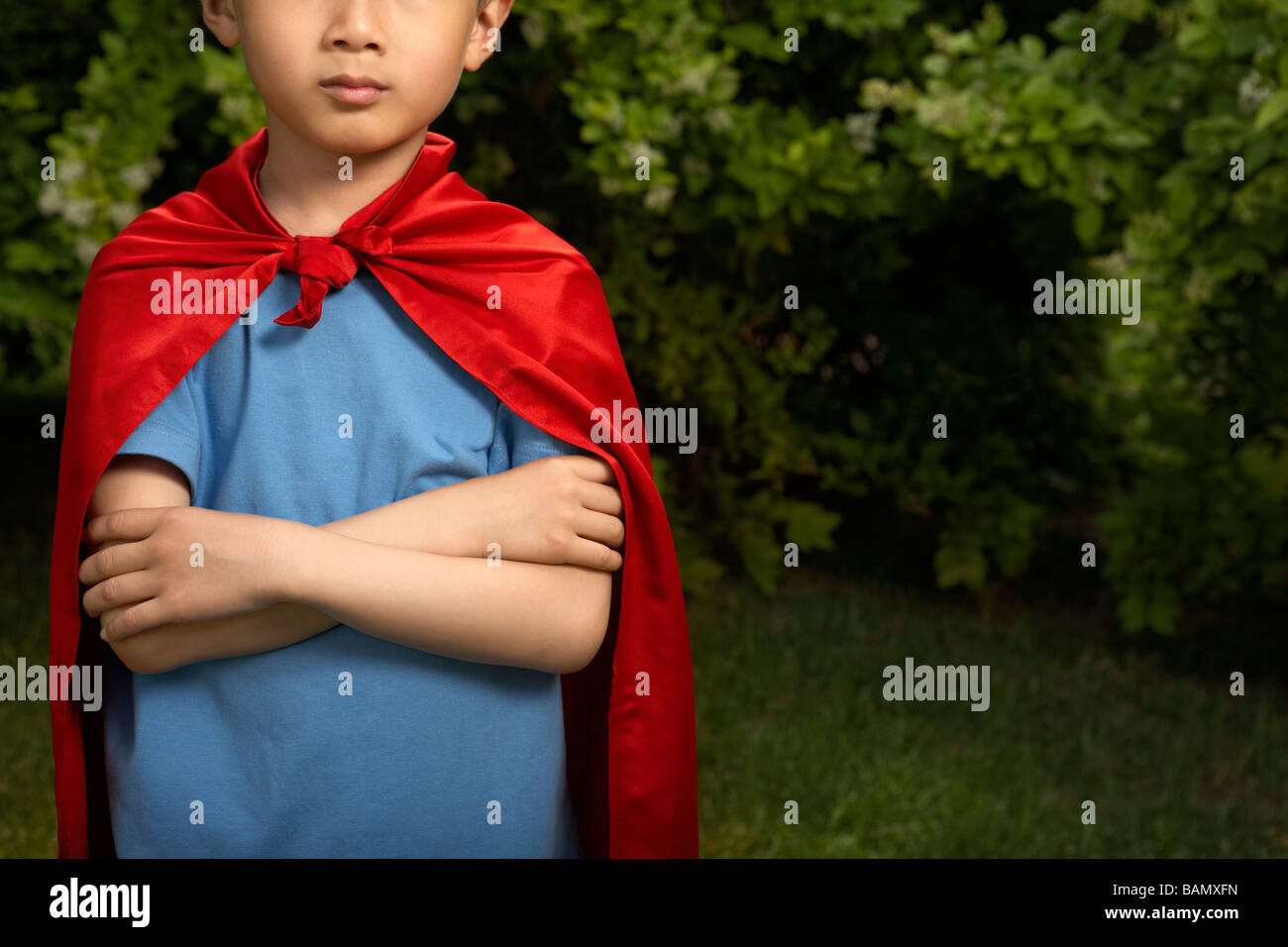 Boy In Red Cape Playing In Garden Stock Photo - Alamy