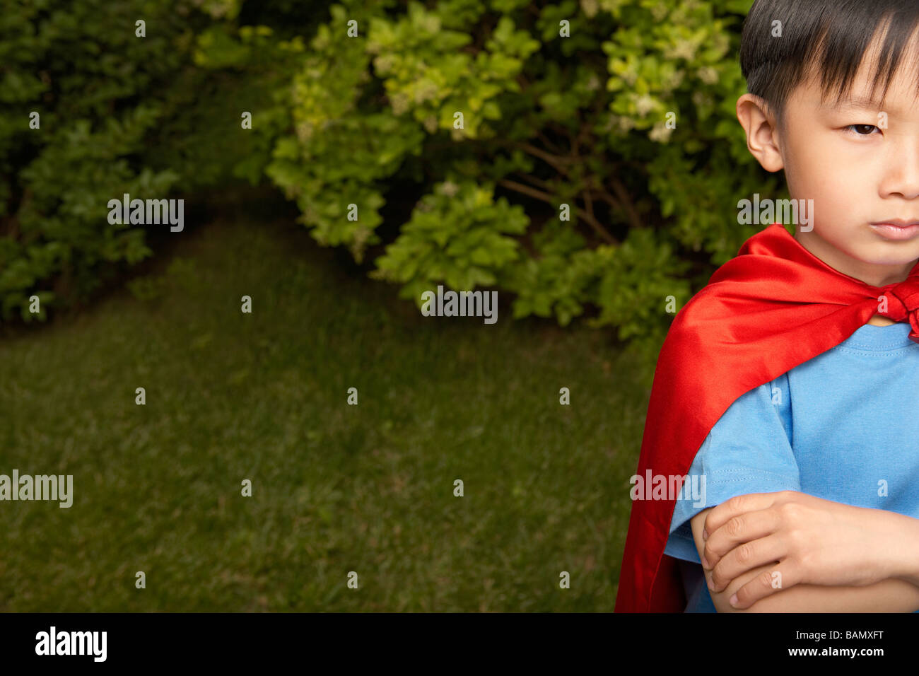 Boy In Red Cape Playing In Garden Stock Photo - Alamy