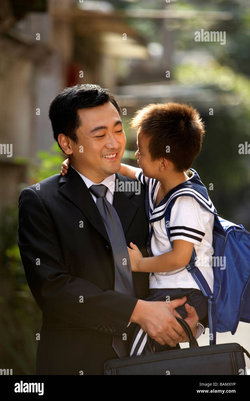 A father picks his son up from school Stock Photo - Alamy