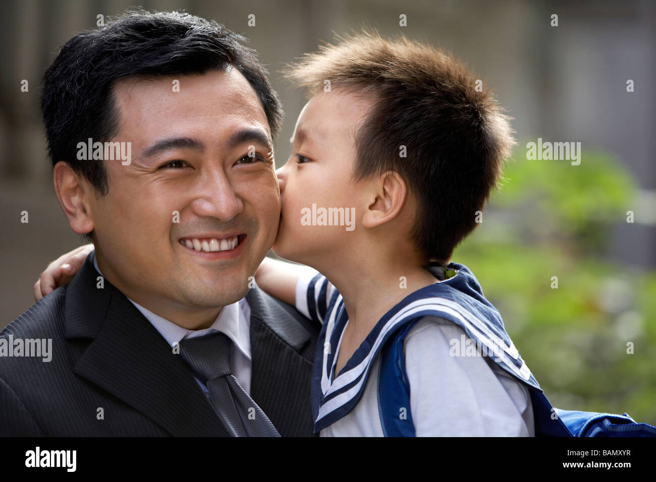 A father picks his son up from school Stock Photo - Alamy