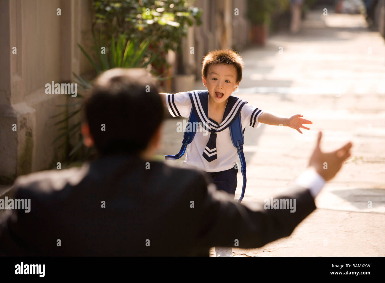 A father picks his son up from school Stock Photo - Alamy