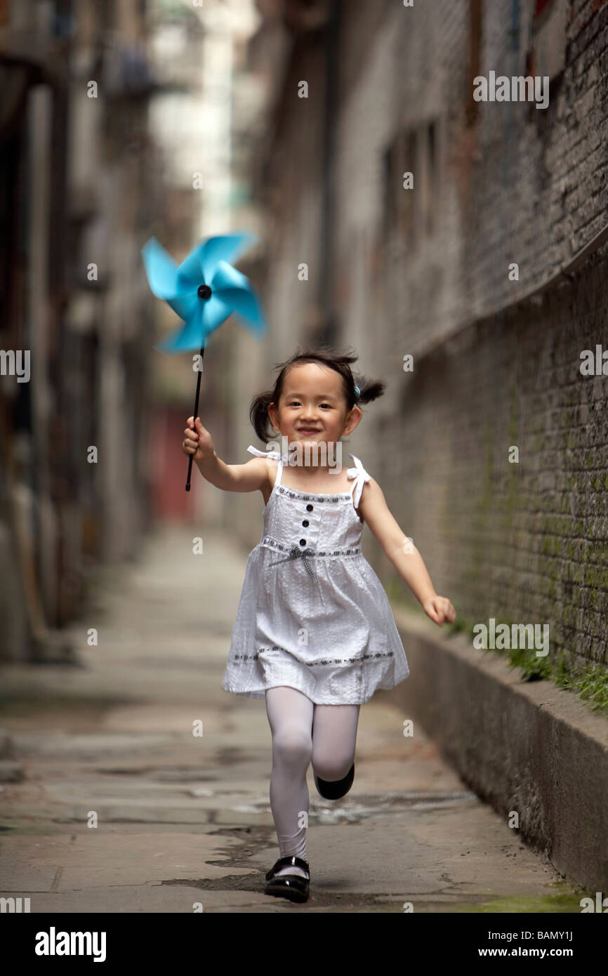 A child runs with a paper pinwheel Stock Photo - Alamy