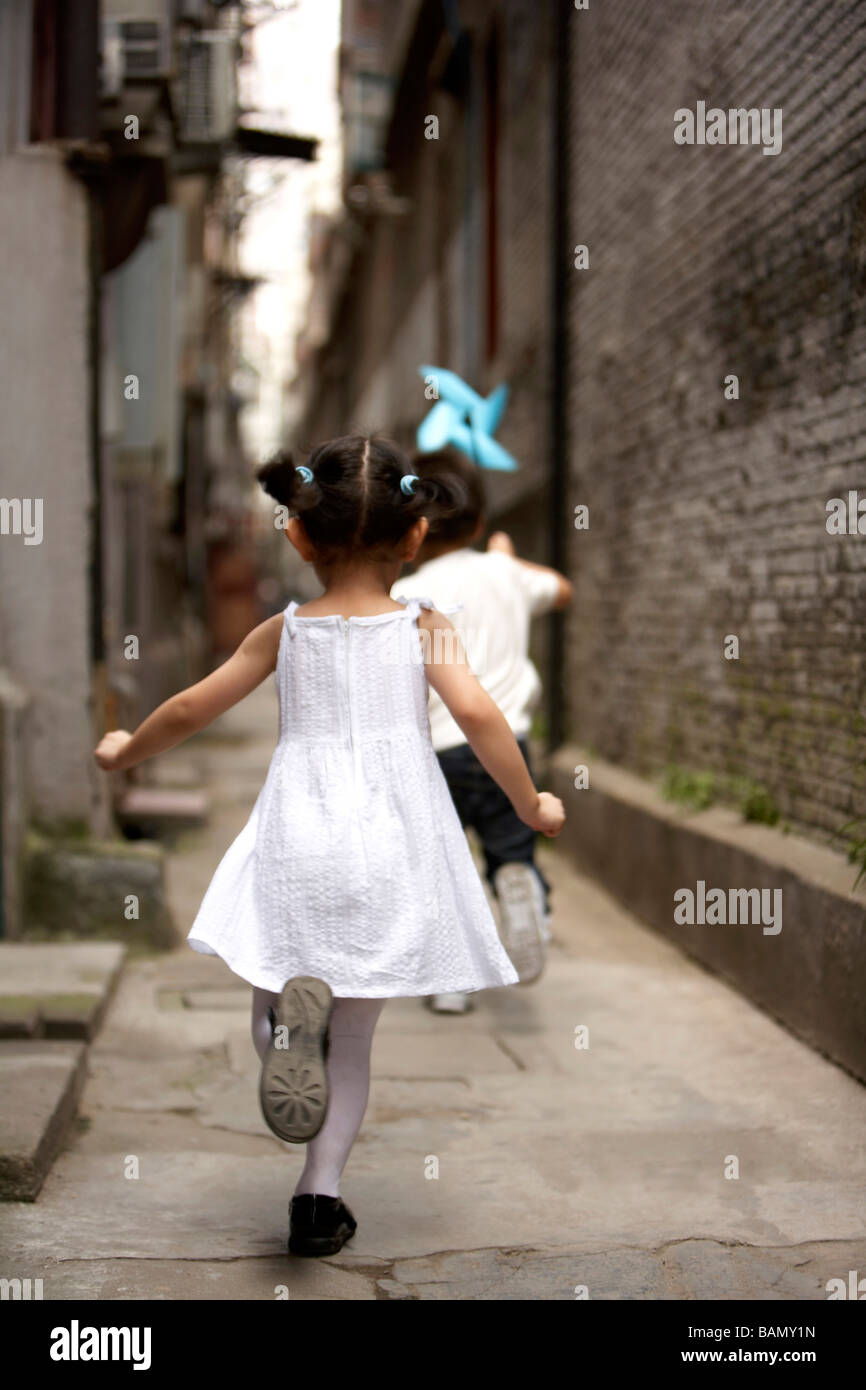 Children run with a paper pinwheel Stock Photo - Alamy