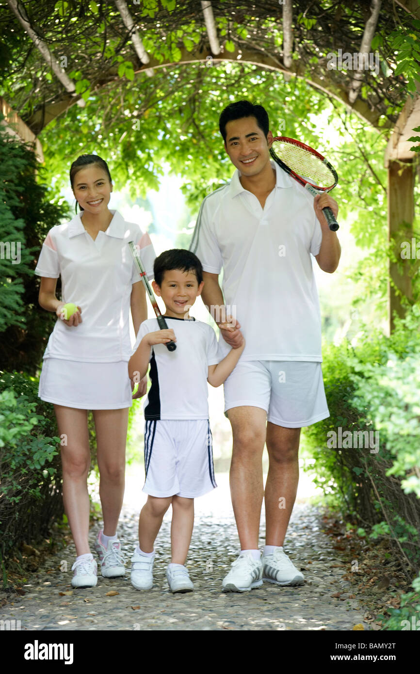 A one child family goes to play tennis Stock Photo - Alamy