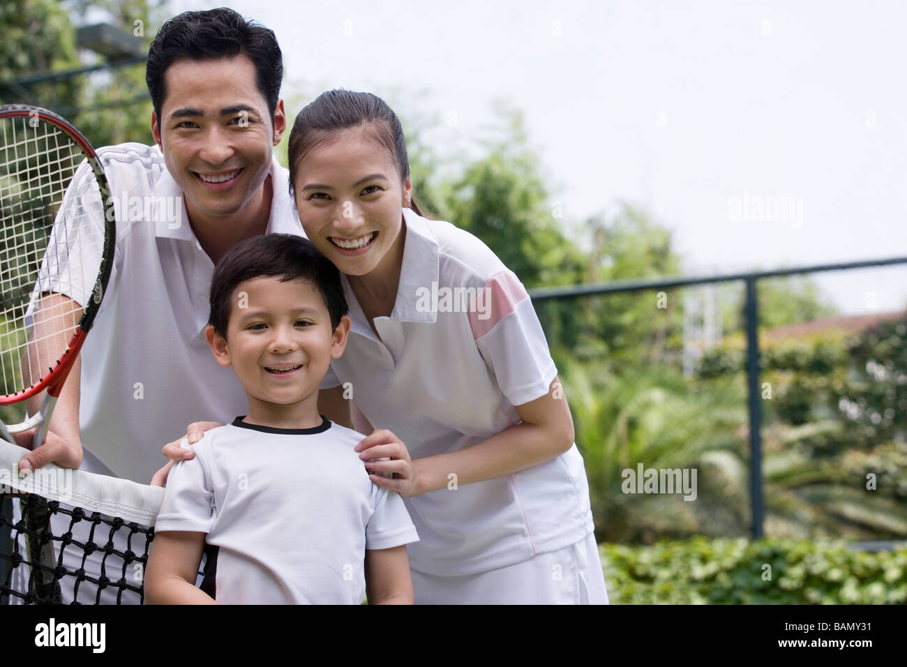 Portrait of a one child family on the tennis court Stock Photo - Alamy
