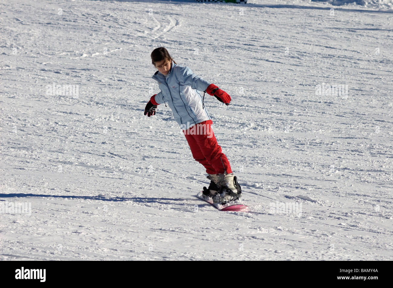 Little girl practicing snowboard Stock Photo - Alamy