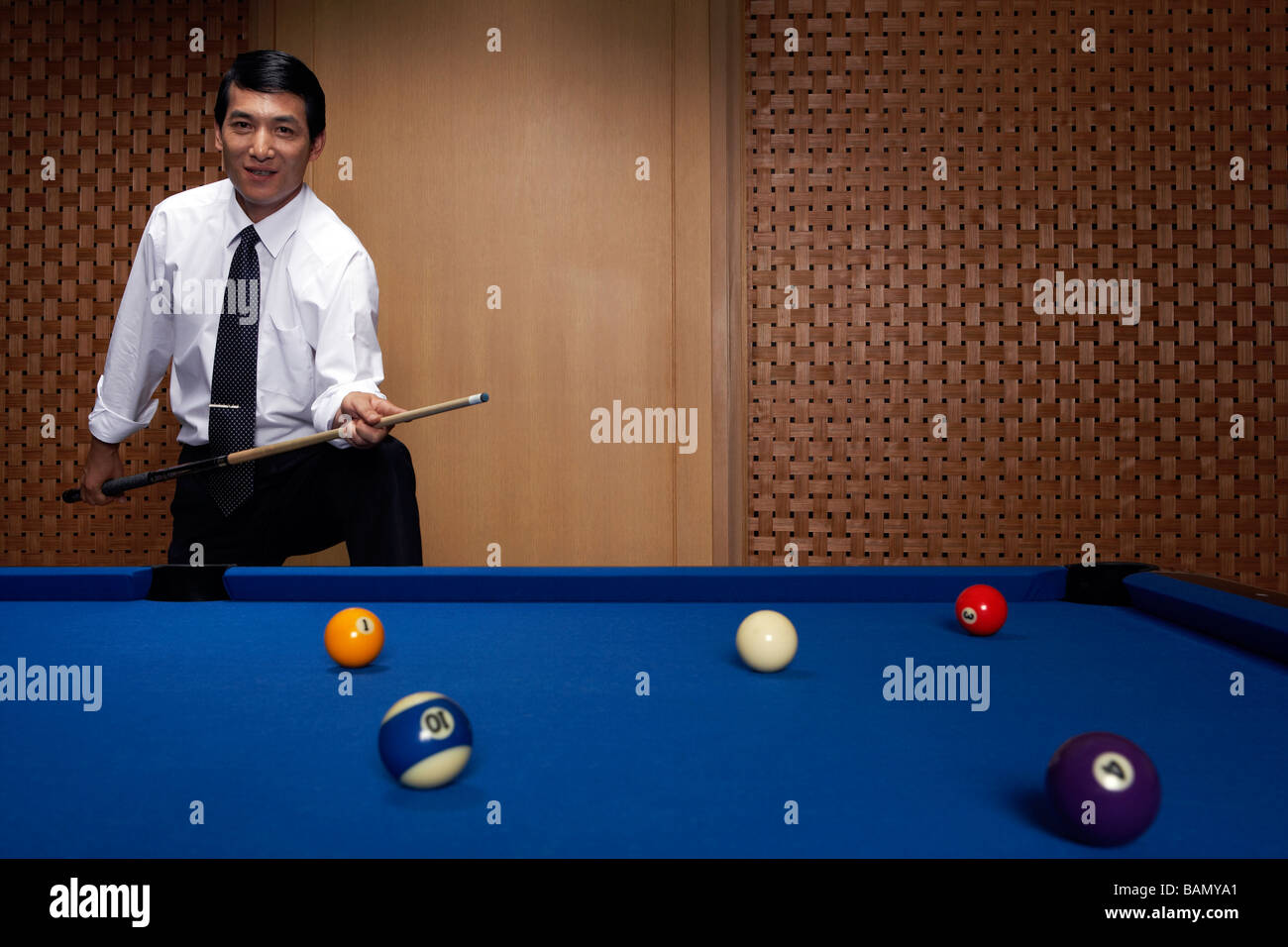 Portrait of a businessman at the billiards table Stock Photo - Alamy