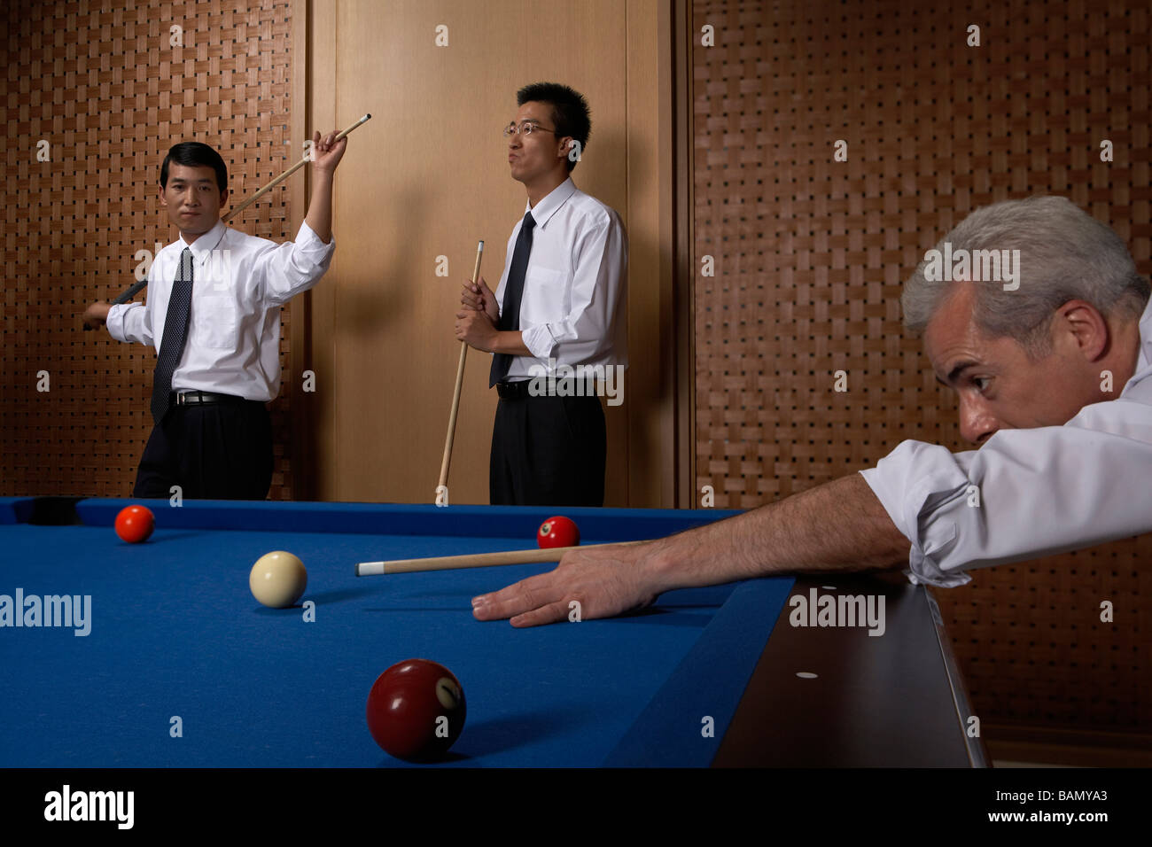 Three professionals play billiards Stock Photo - Alamy
