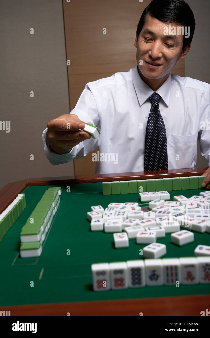 A businessman plays Mahjong Stock Photo - Alamy