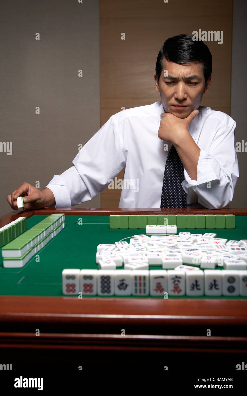 A businessman plays Mahjong Stock Photo - Alamy
