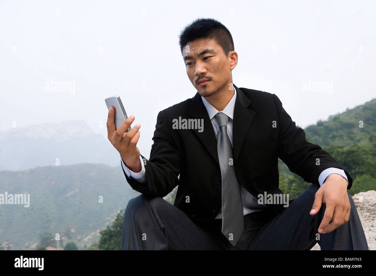 Chinese man uses mobile phone hi-res stock photography and images - Alamy