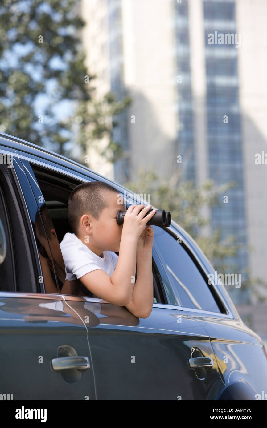 Young boy leaning out car window Stock Photo - Alamy