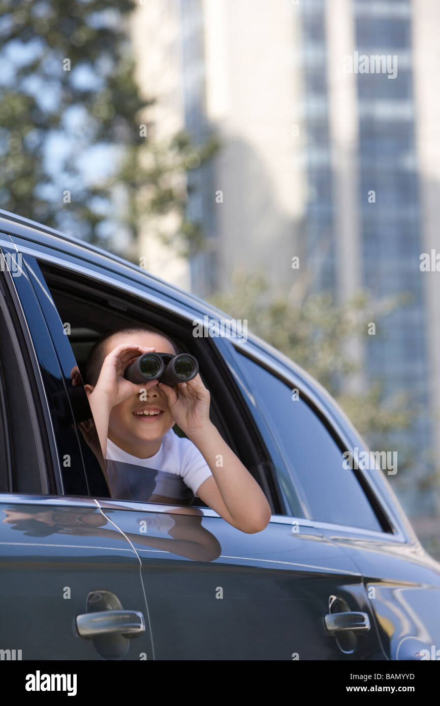 Young boy leaning out car window Stock Photo - Alamy