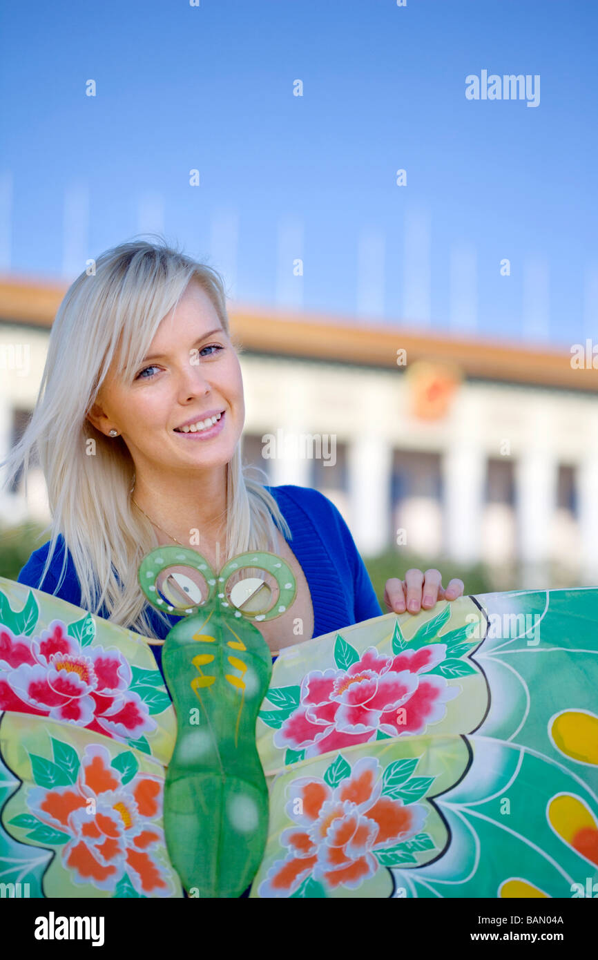 Young woman holding a traditional Chinese paper kite, Tiananmen Square ...