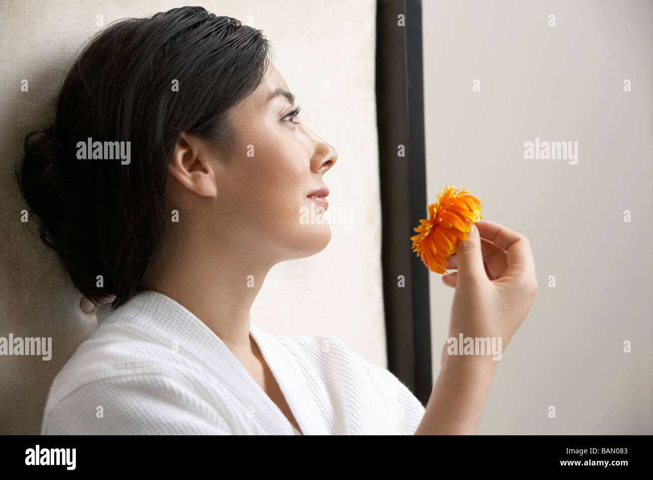 Woman with a daisy in a spa Stock Photo - Alamy