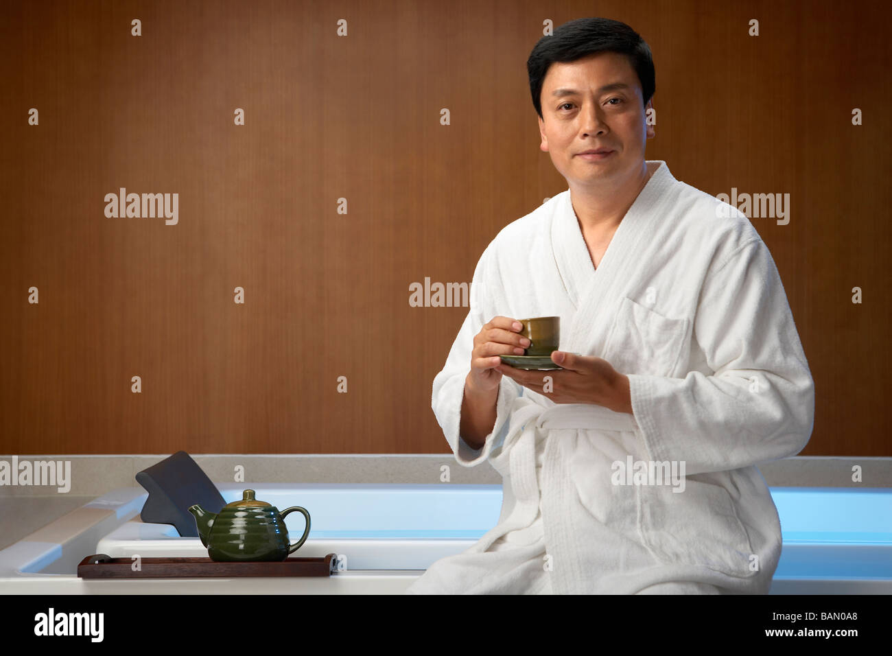Man drinking tea at a spa Stock Photo - Alamy