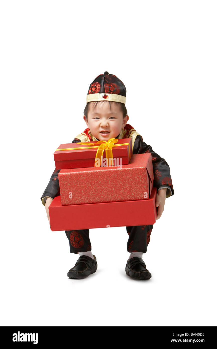 A young boy carrying presents for Chinese New Year Stock Photo - Alamy