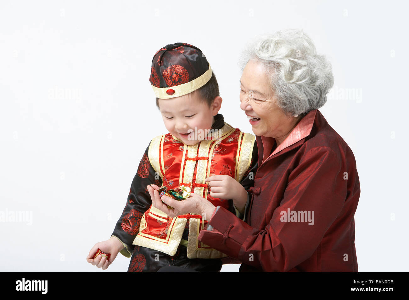 A grandmother shares candy with her grandson on Chinese New Year Stock ...