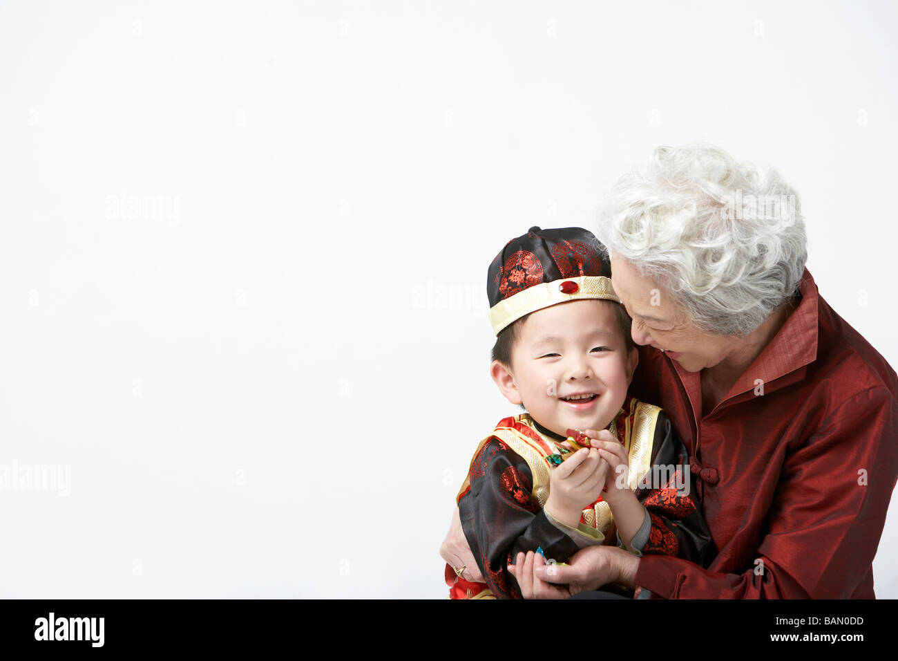 A grandmother shares candy with her grandson on Chinese New Year Stock ...
