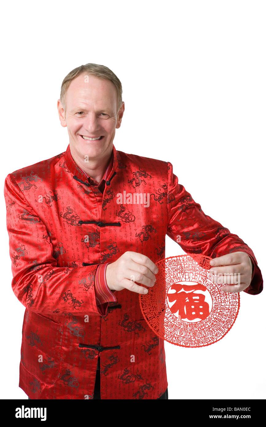 A man holds out a paper cutting with the Chinese character for wealth ...