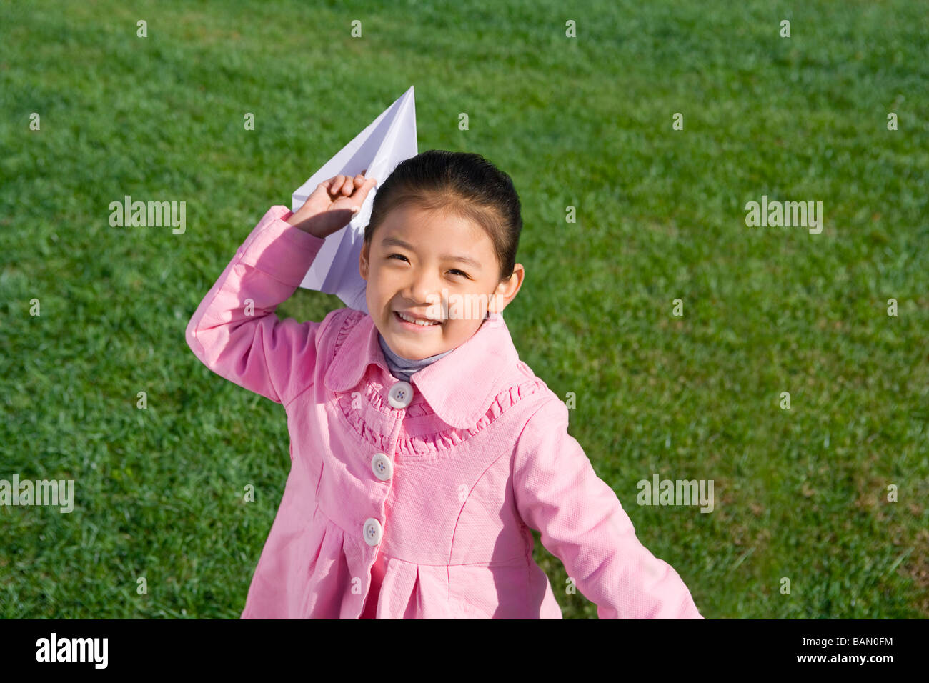 A young girl throwing a paper airplane Stock Photo - Alamy